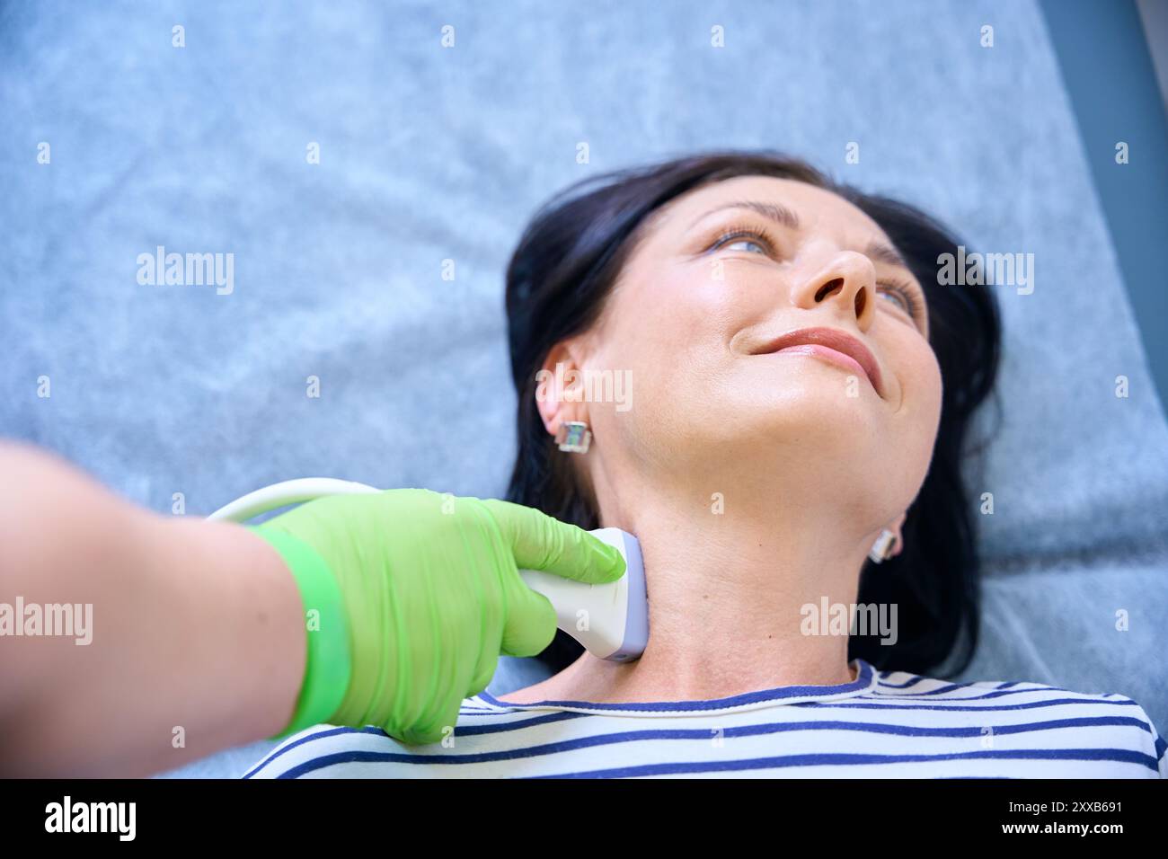 Specialist performs ultrasound examination of lymph nodes of middle ...