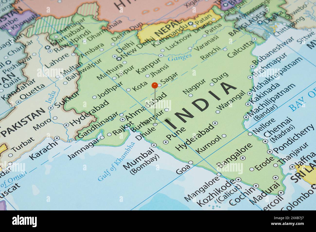 Close up to a Dhule city with an orange pin needle into India country ...