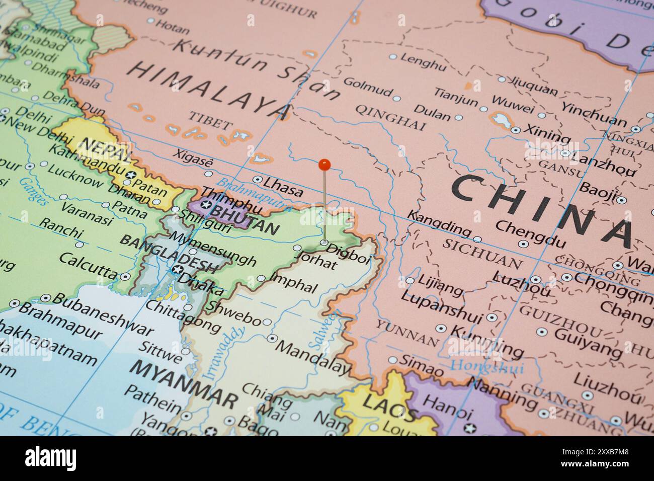 Close up to a Digboi city with an orange pin needle into India country ...