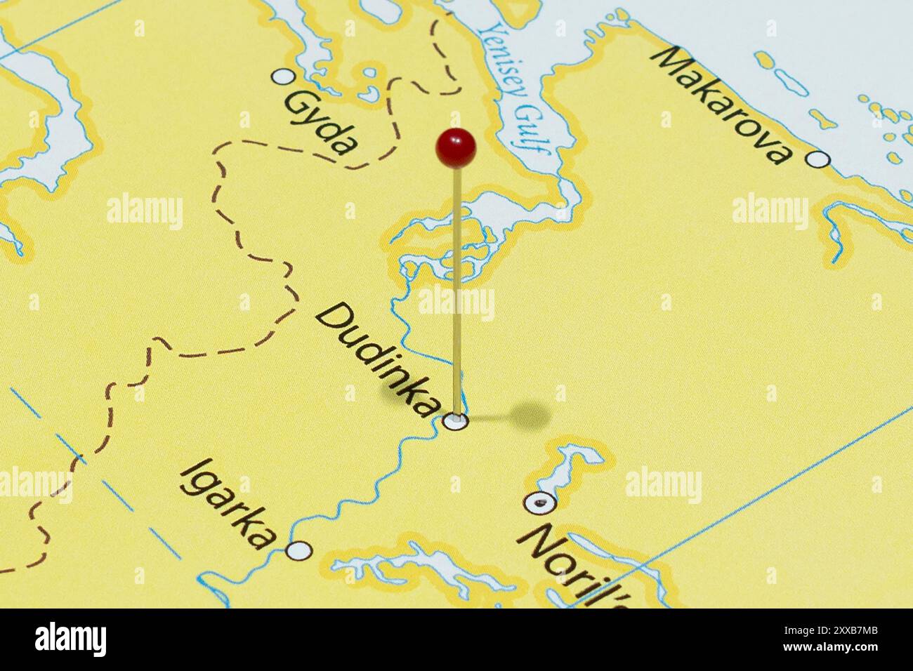 Close up to a Dudinka city with a red pin needle into Russia country ...