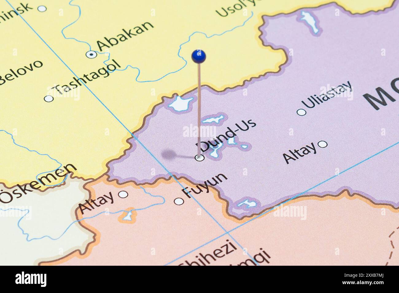 Close up to a Dund Us city with a blue pin needle into Mongolia country ...