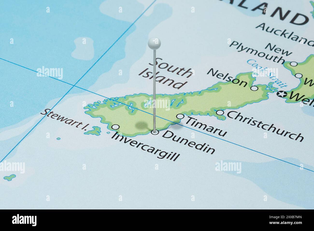 Close up to a Dunedin city with a white pin needle into New Zealand ...