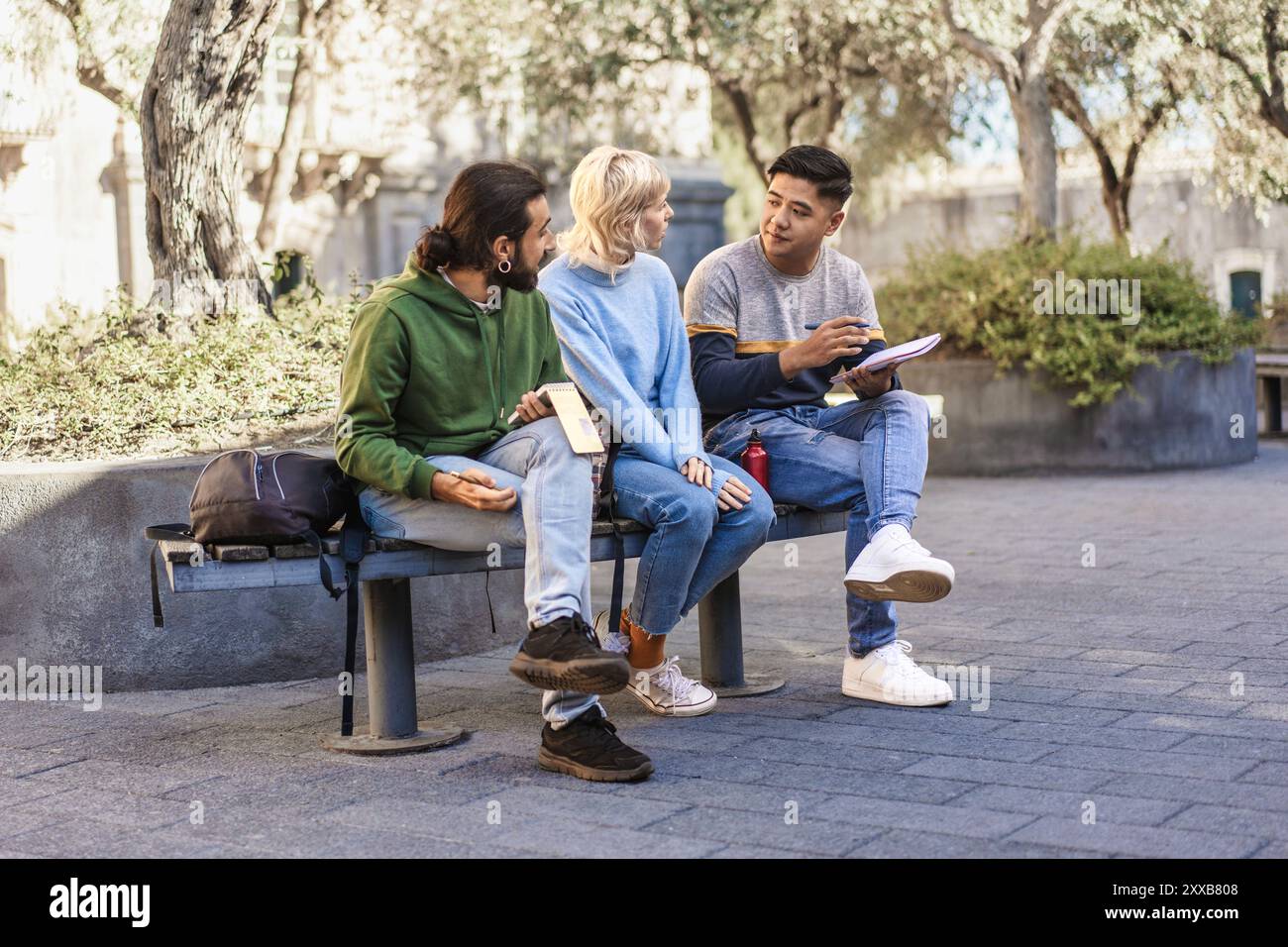 Group of diverse young students collaborating on university campus ...