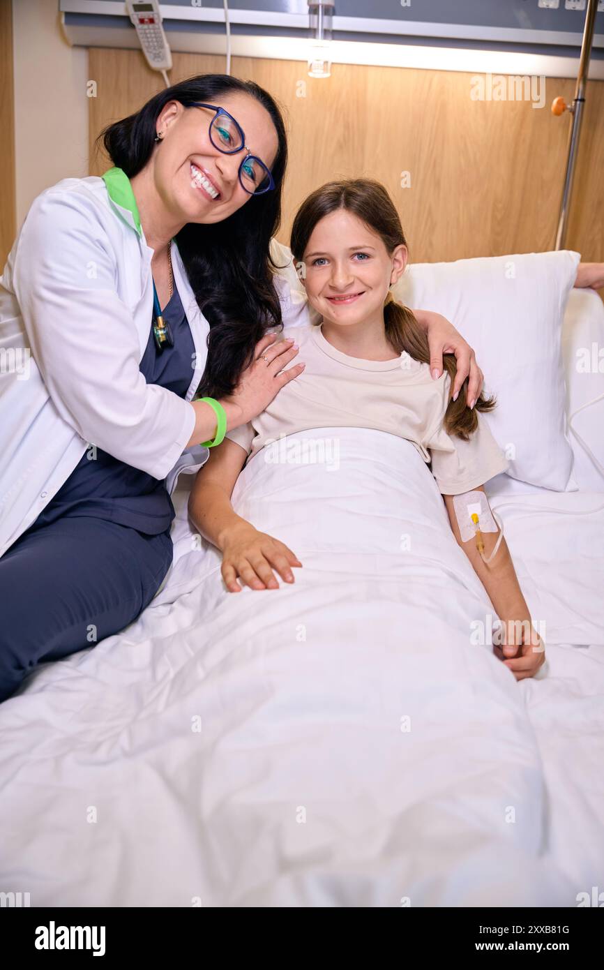 Smiling doctor hugging sick girl Stock Photo - Alamy