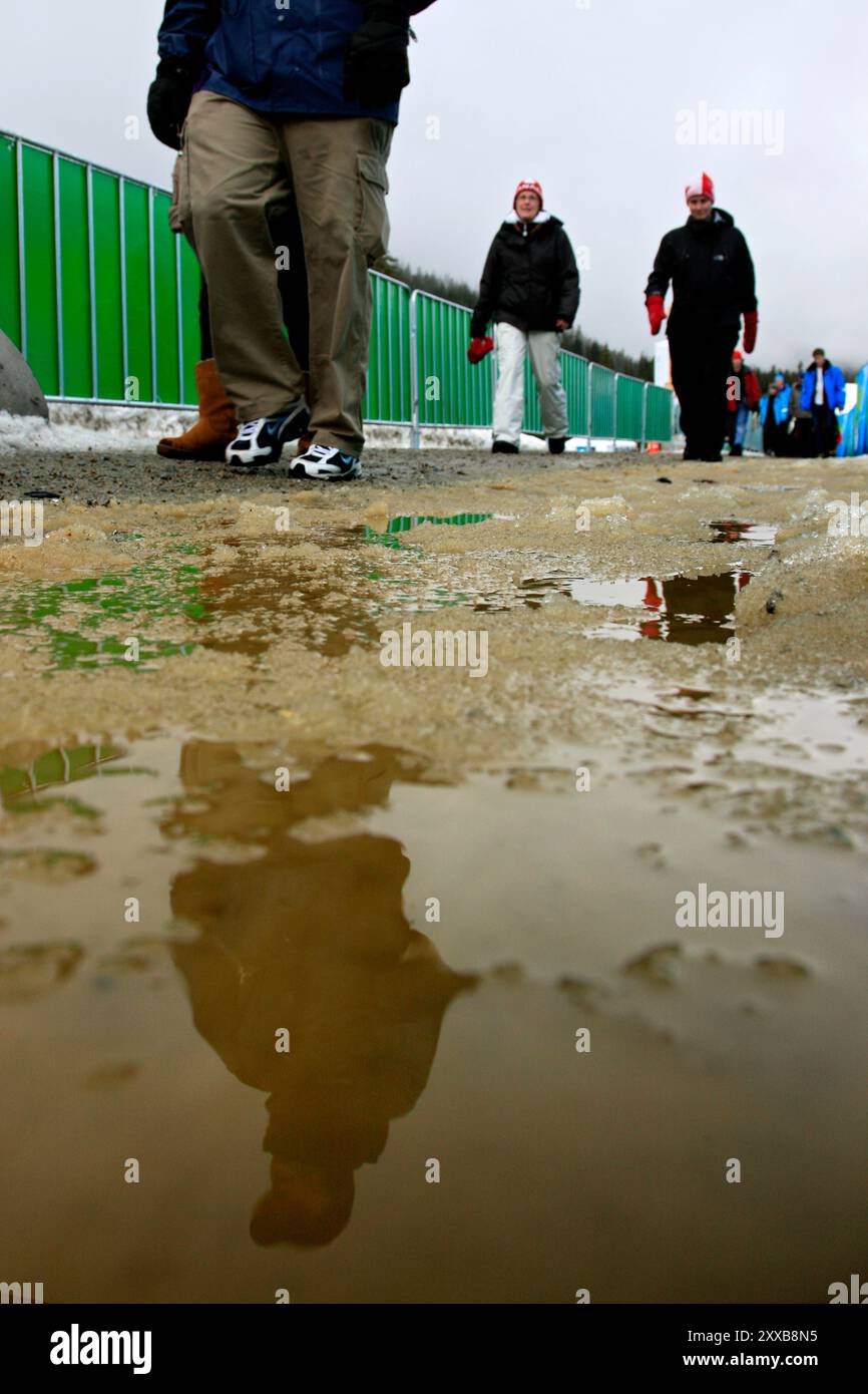 Biathlon Men Sprint. Warm weather and rain turns the roads and paths at ...