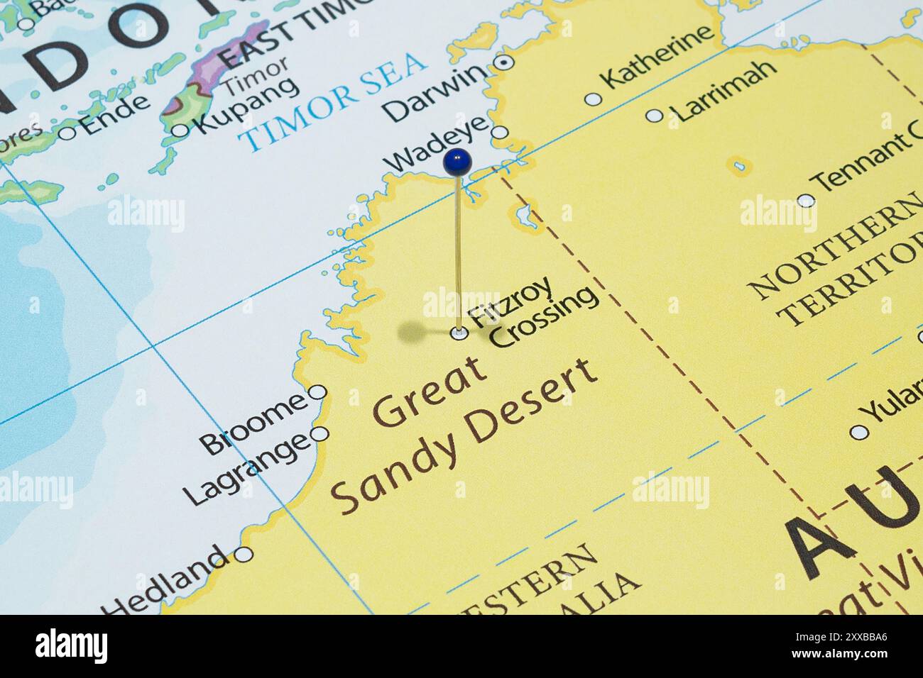 Close up to a Fitzroy Crossing city with a blue pin needle into ...