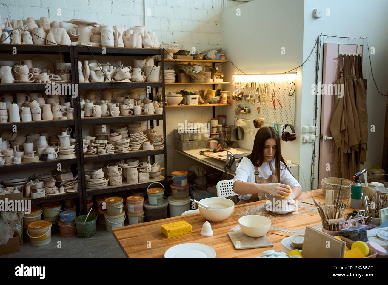 Female master potter, clay cutting special tool Stock Photo - Alamy