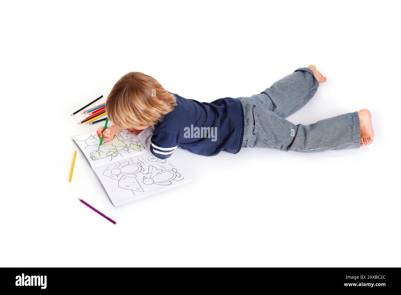 Child lying on the floor working in a coloring book close up Stock ...