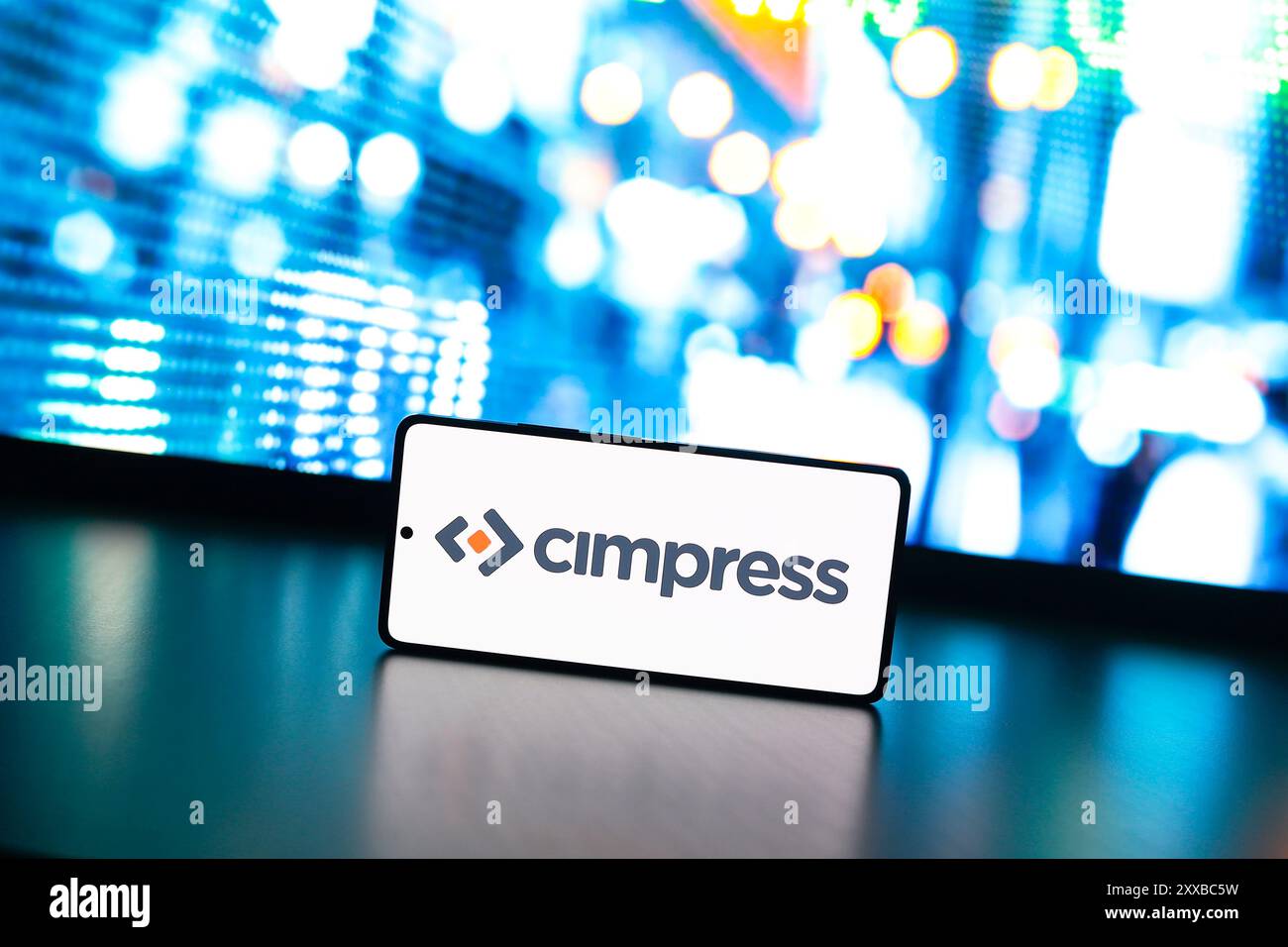 In this photo illustration, the Cimpress logo is displayed on a smartphone screen Stock Photo ...