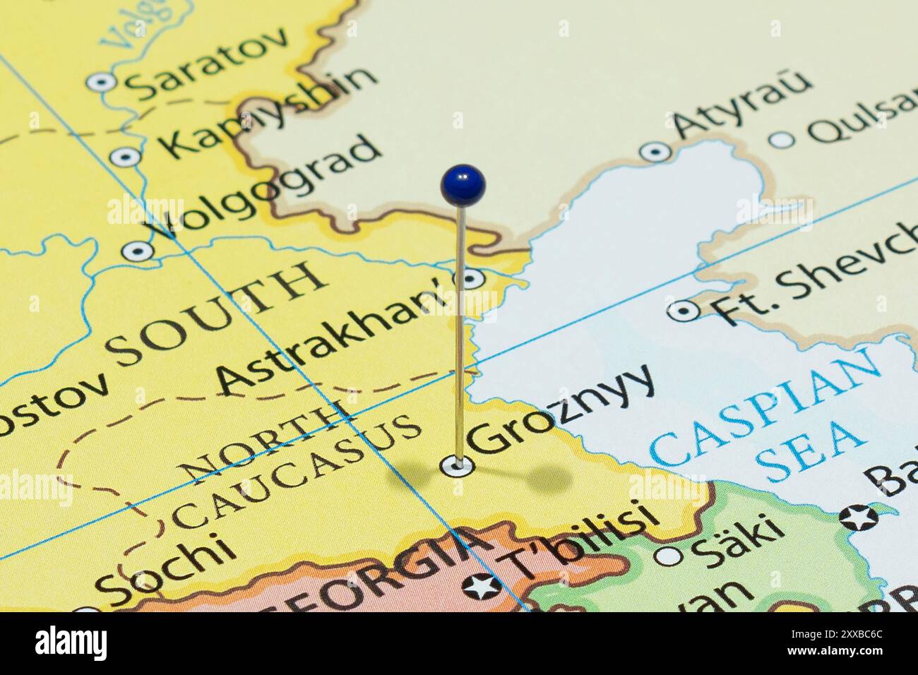 Close up to a Grozny city with a blue pin needle into Russia country ...