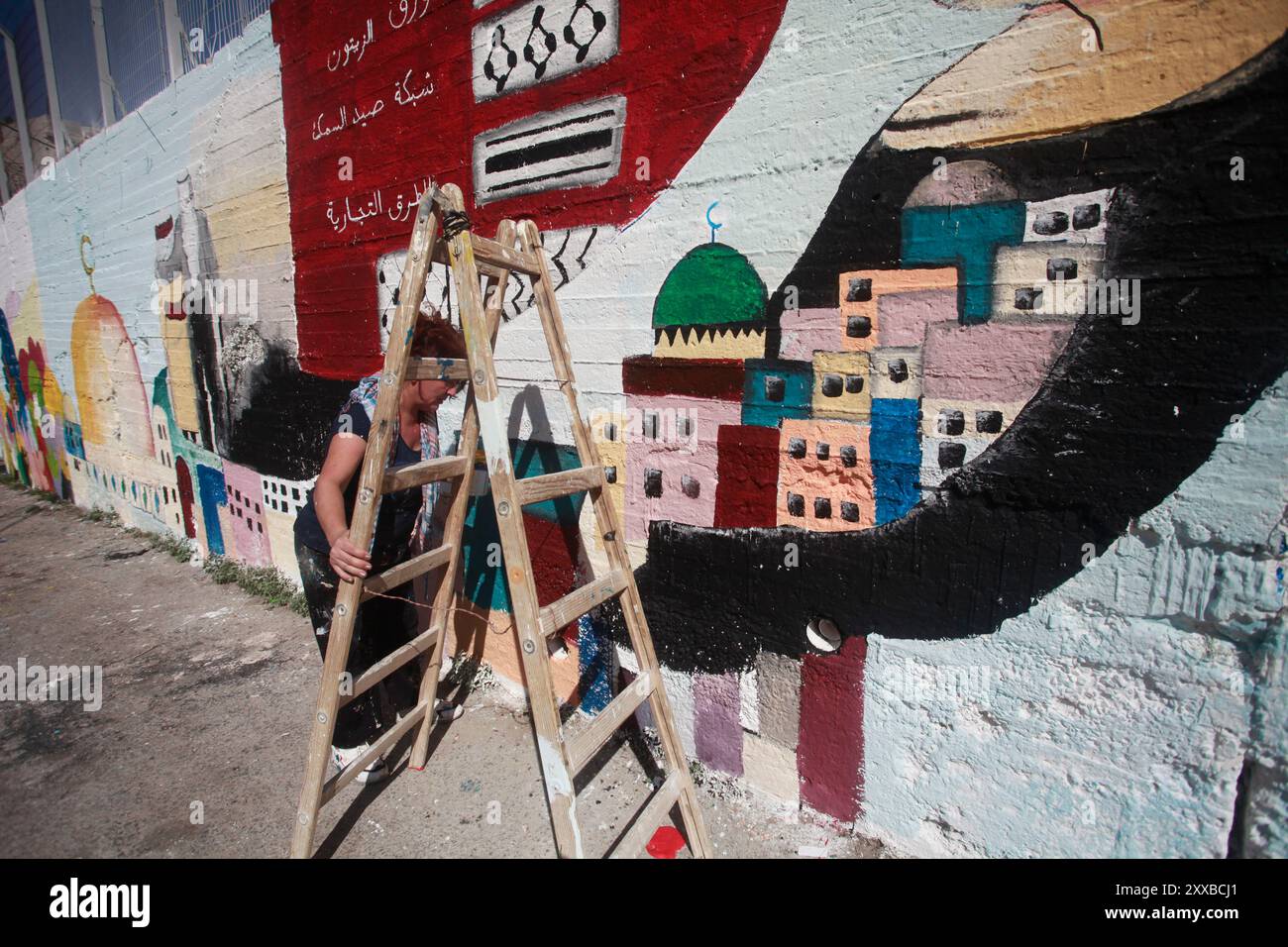 A Palestinian artist paints a mural of the Dome of the Rock, Al-Aqsa ...