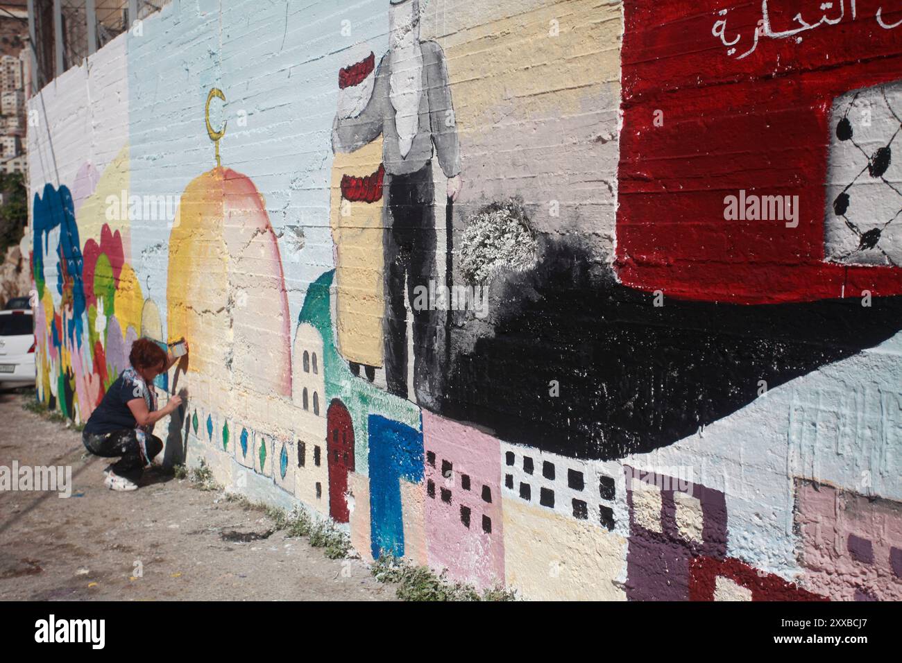 A Palestinian artist paints a mural of the Dome of the Rock, Al-Aqsa ...
