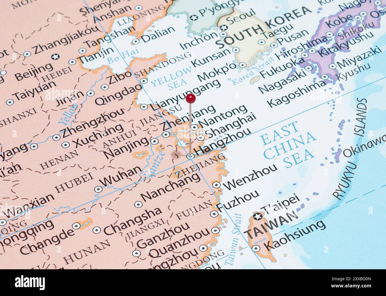 Close up to a Hangzhou city with a red pin needle into China country ...