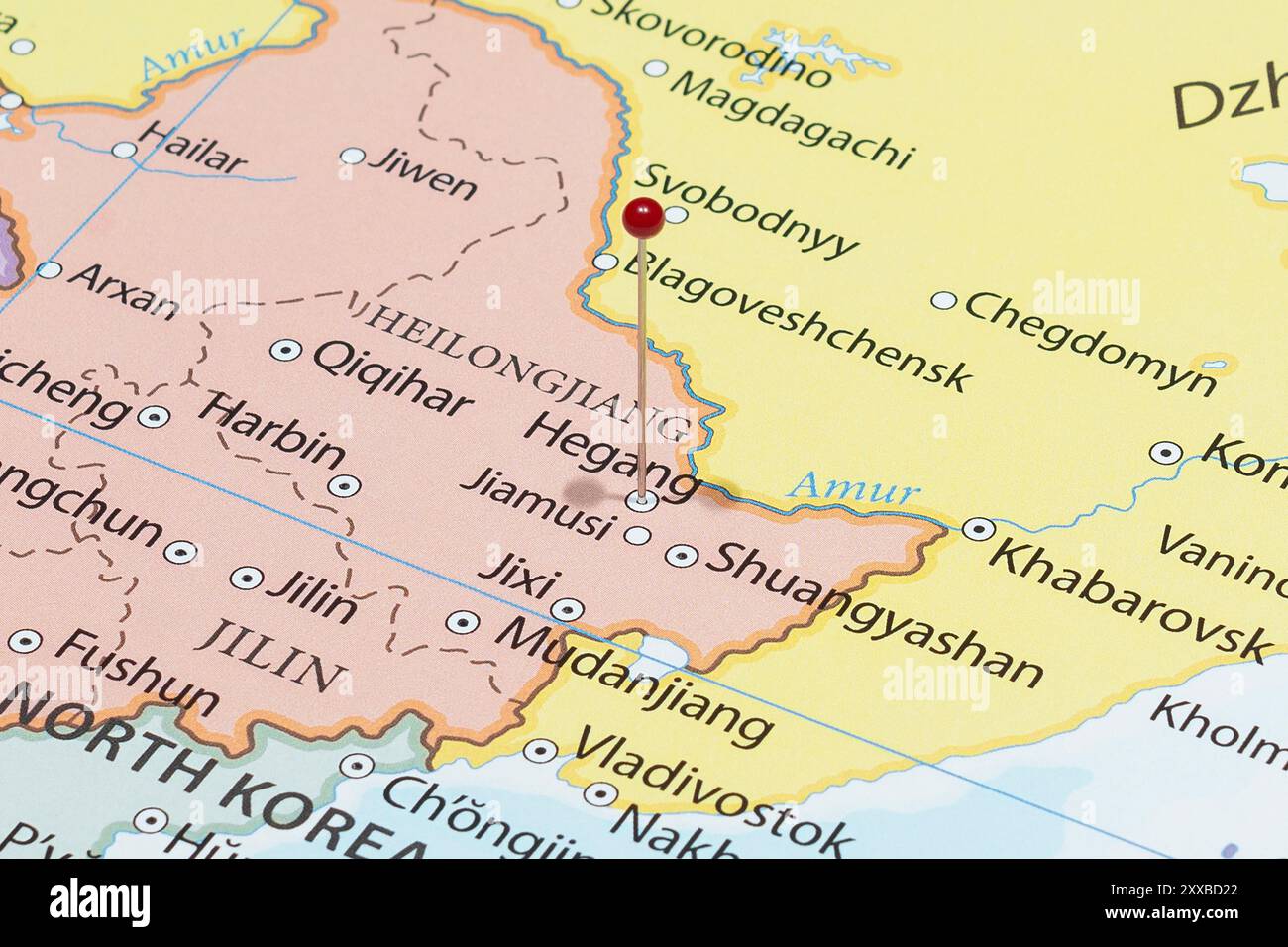 Close up to a Hegang city with a red pin needle into China country ...