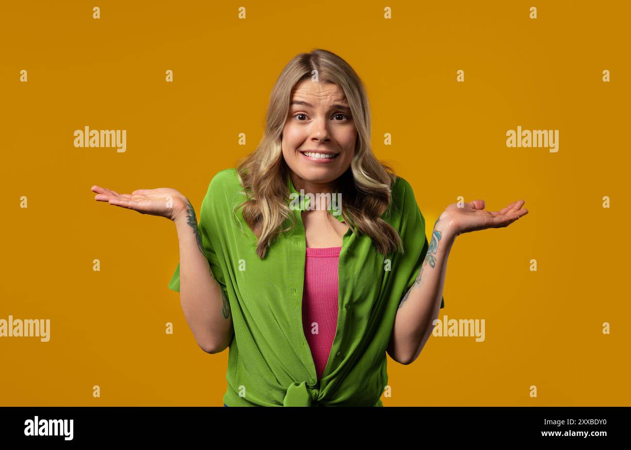 Confused stylish 30s aged woman, shoulders up - can't help, makes ...