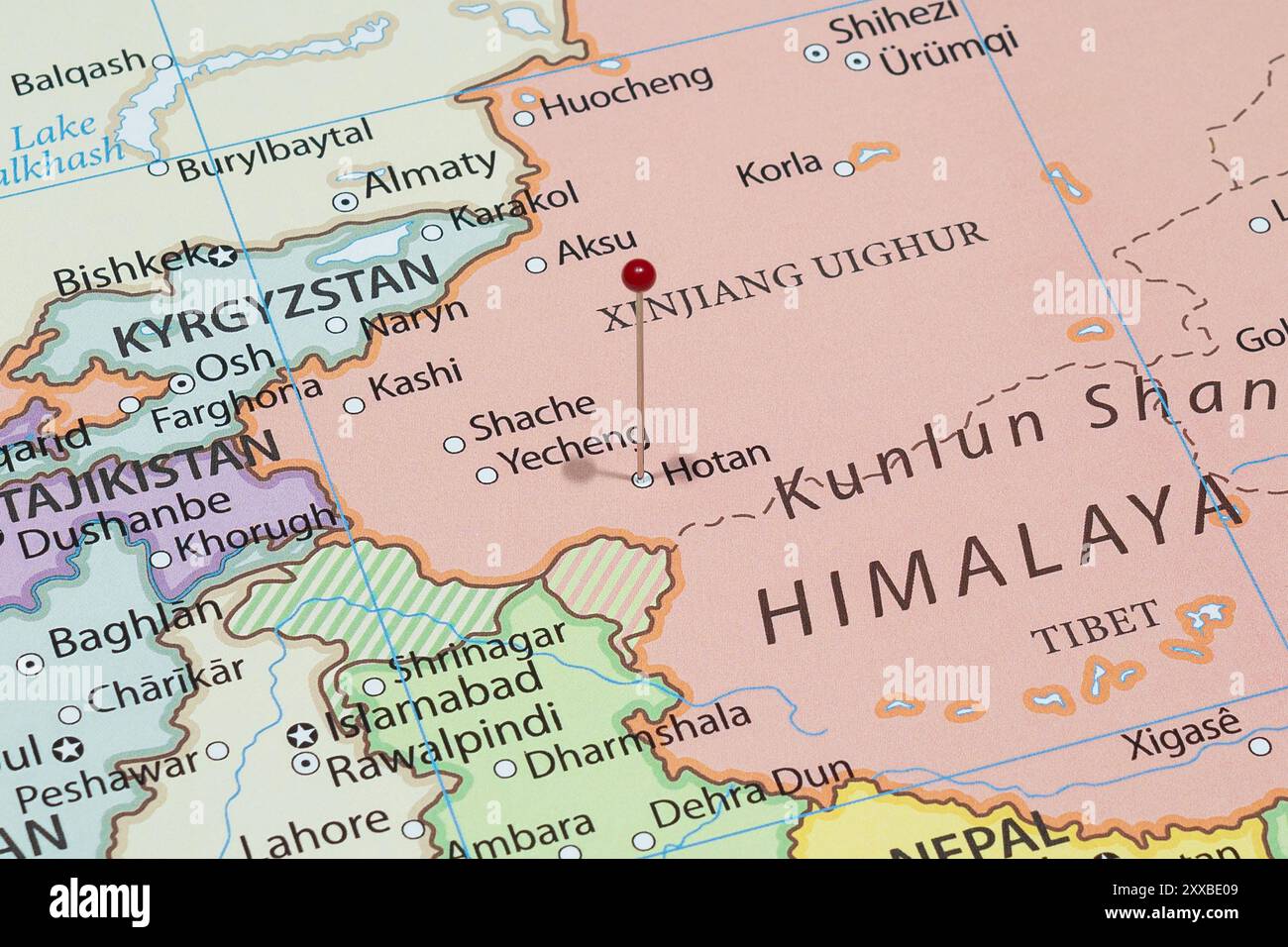 Close up to a Hotan city with a red pin needle into China country ...