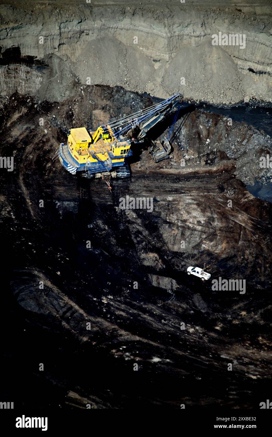 Bitumen rich oil sand is picked up for processing at one of the oil ...