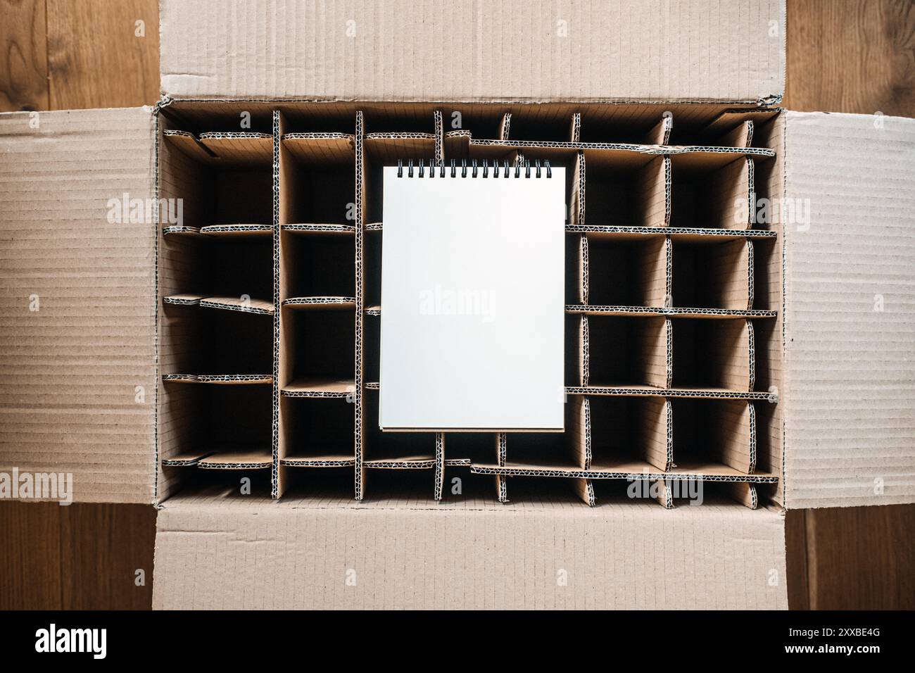 Corrugated cardboard packaging with empty slots and blank white label ...