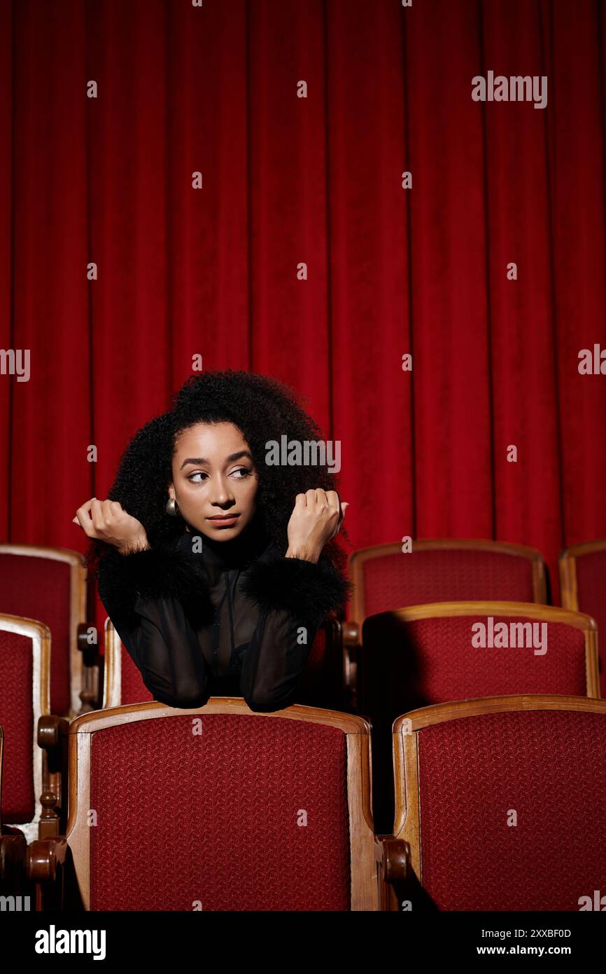 A stylish woman in a theater reacts to a movie playing on screen Stock ...