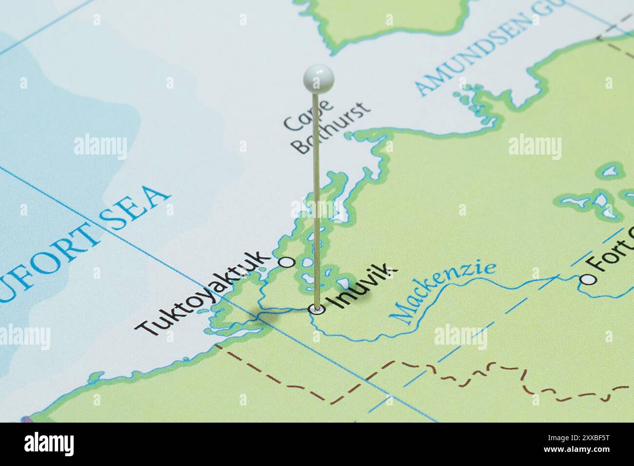 Close up to a Inuvik city with a white pin needle into Canada country ...