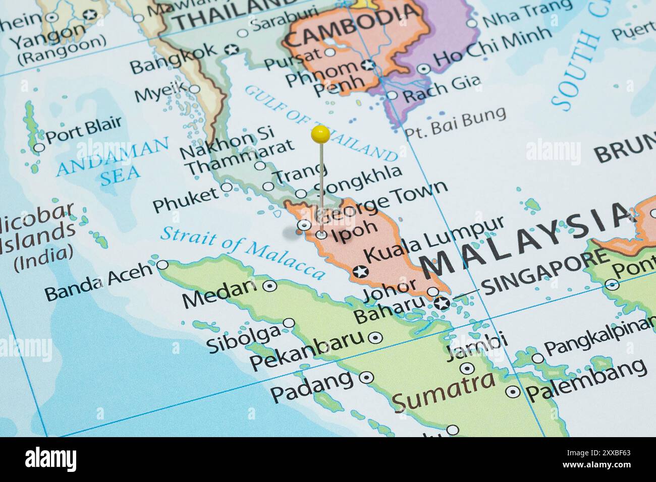 Close up to a Ipoh city with a yellow pin needle into Malaysia country ...