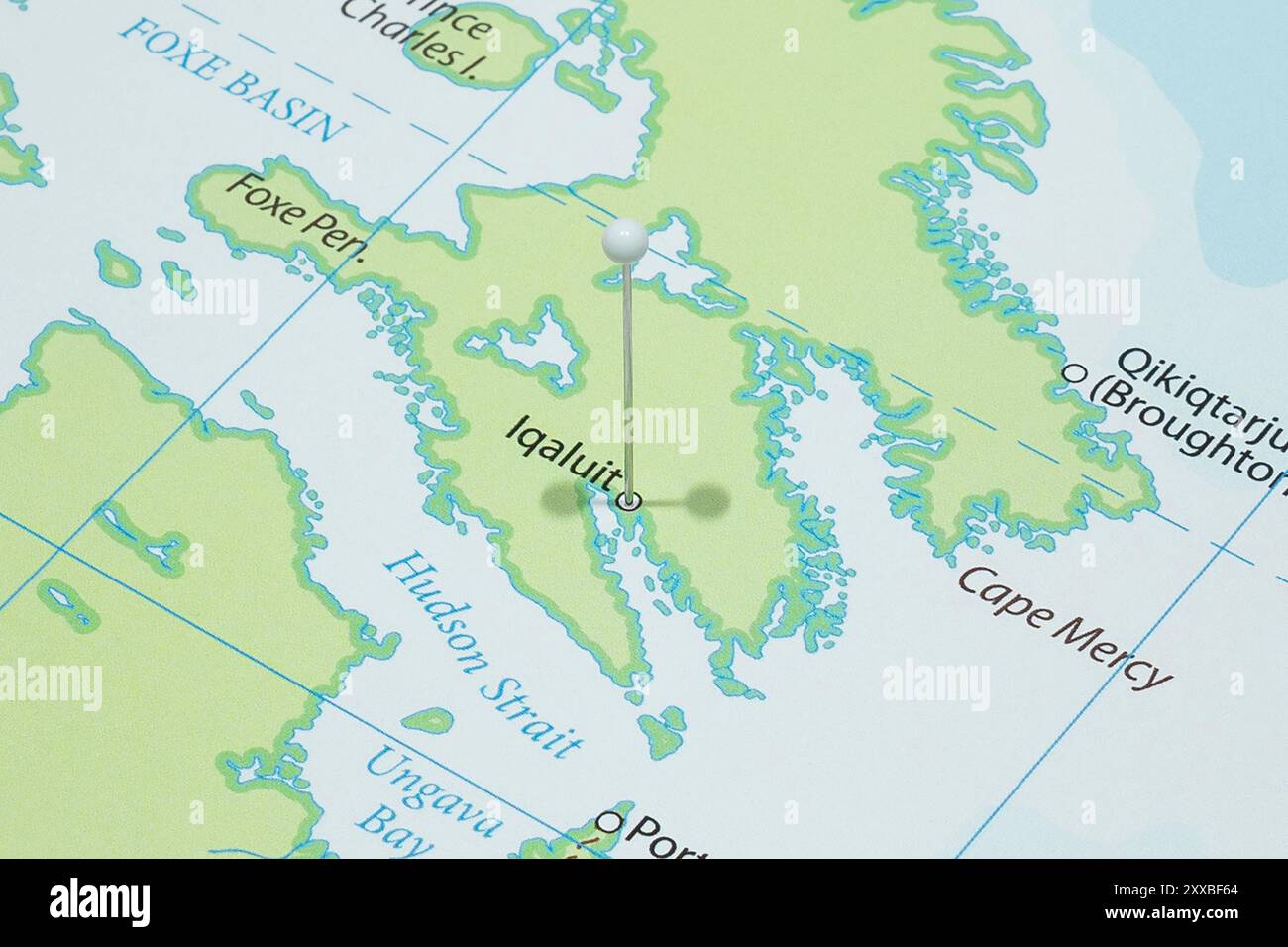Close up to a Iqaluit city with a white pin needle into Canada country ...