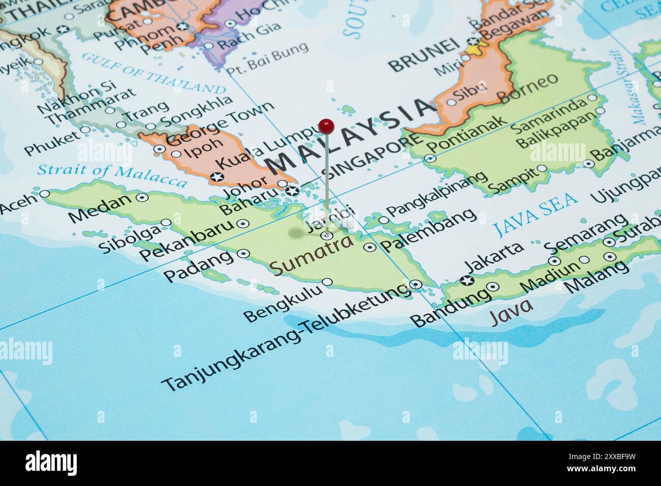 Close up to a Jambi city with a red pin needle into Indonesia country ...