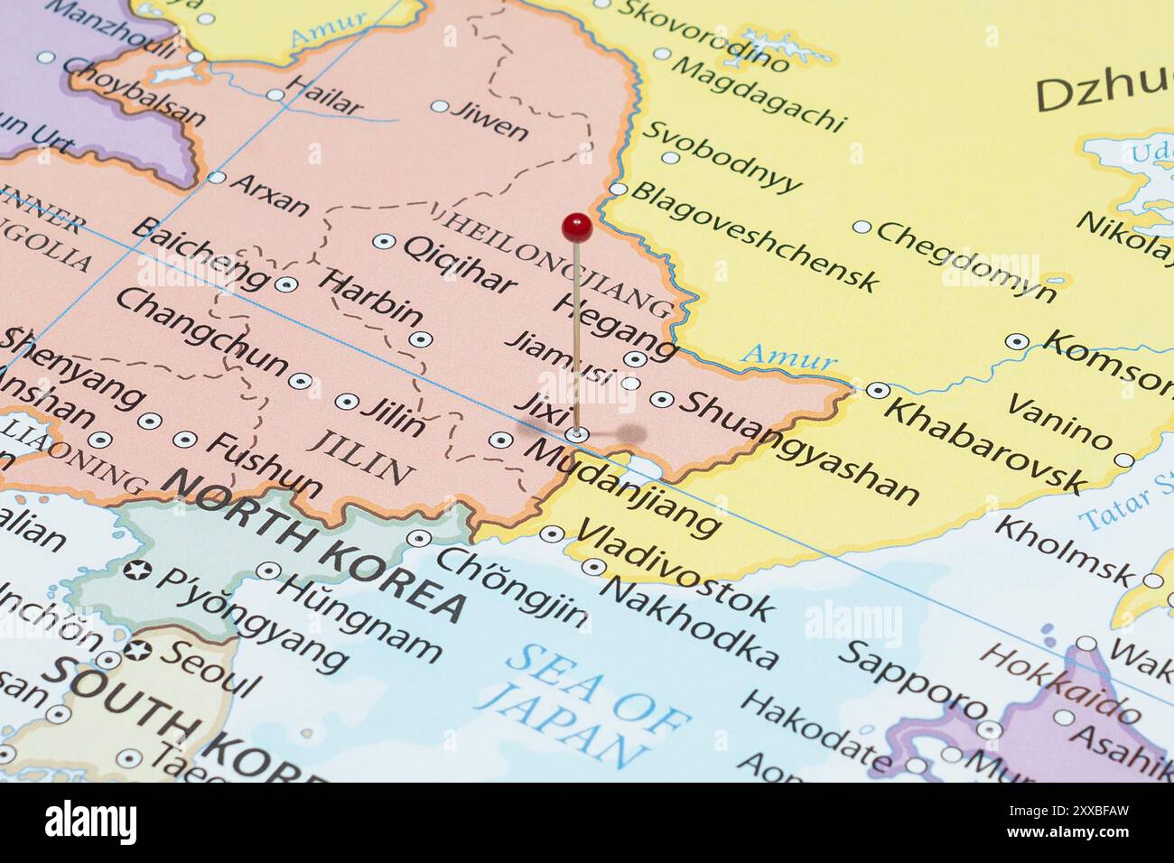 Close up to a Jixi city with a red pin needle into China country ...