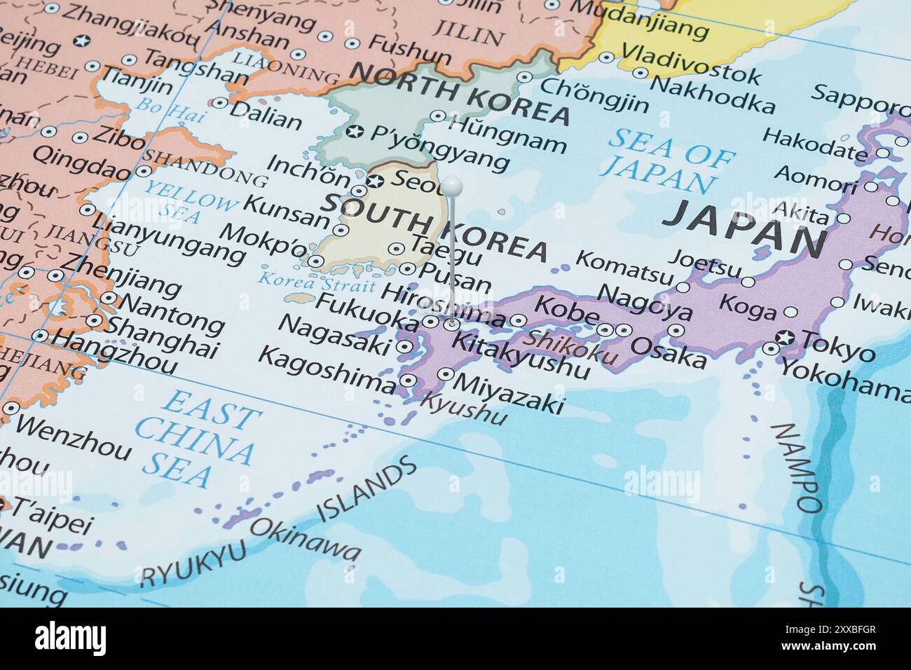 Close up to a Kitakyushu city with a white pin needle into Japan ...