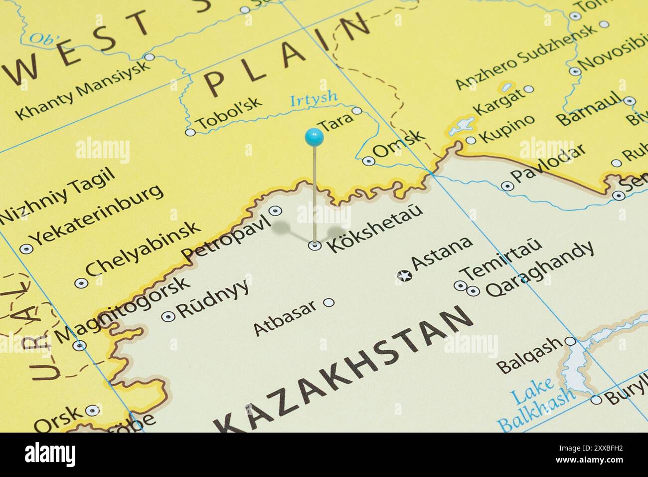 Close up to a Kokshetau city with a light blue pin needle into ...