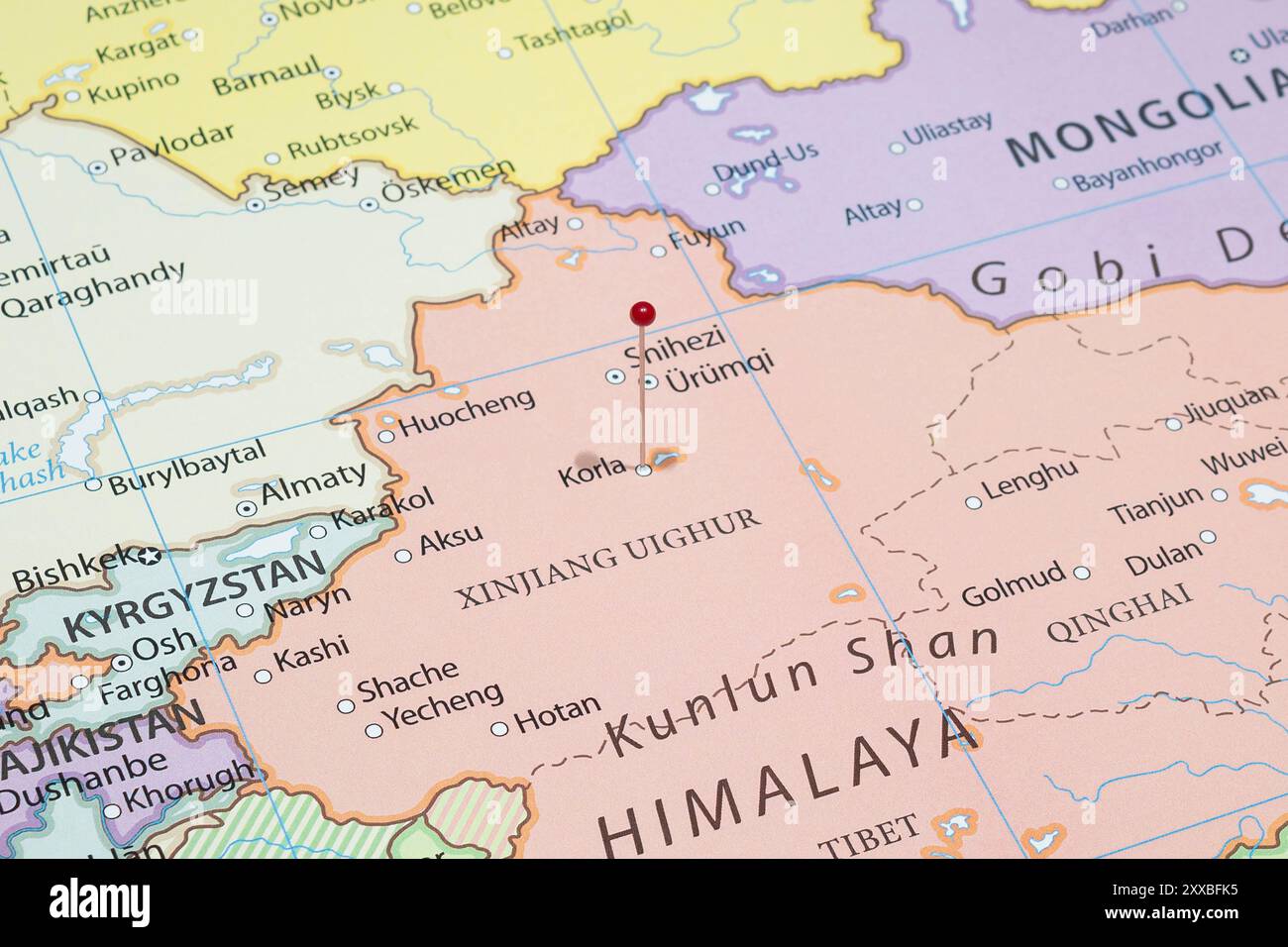 Close up to a Korla city with a red pin needle into China country ...