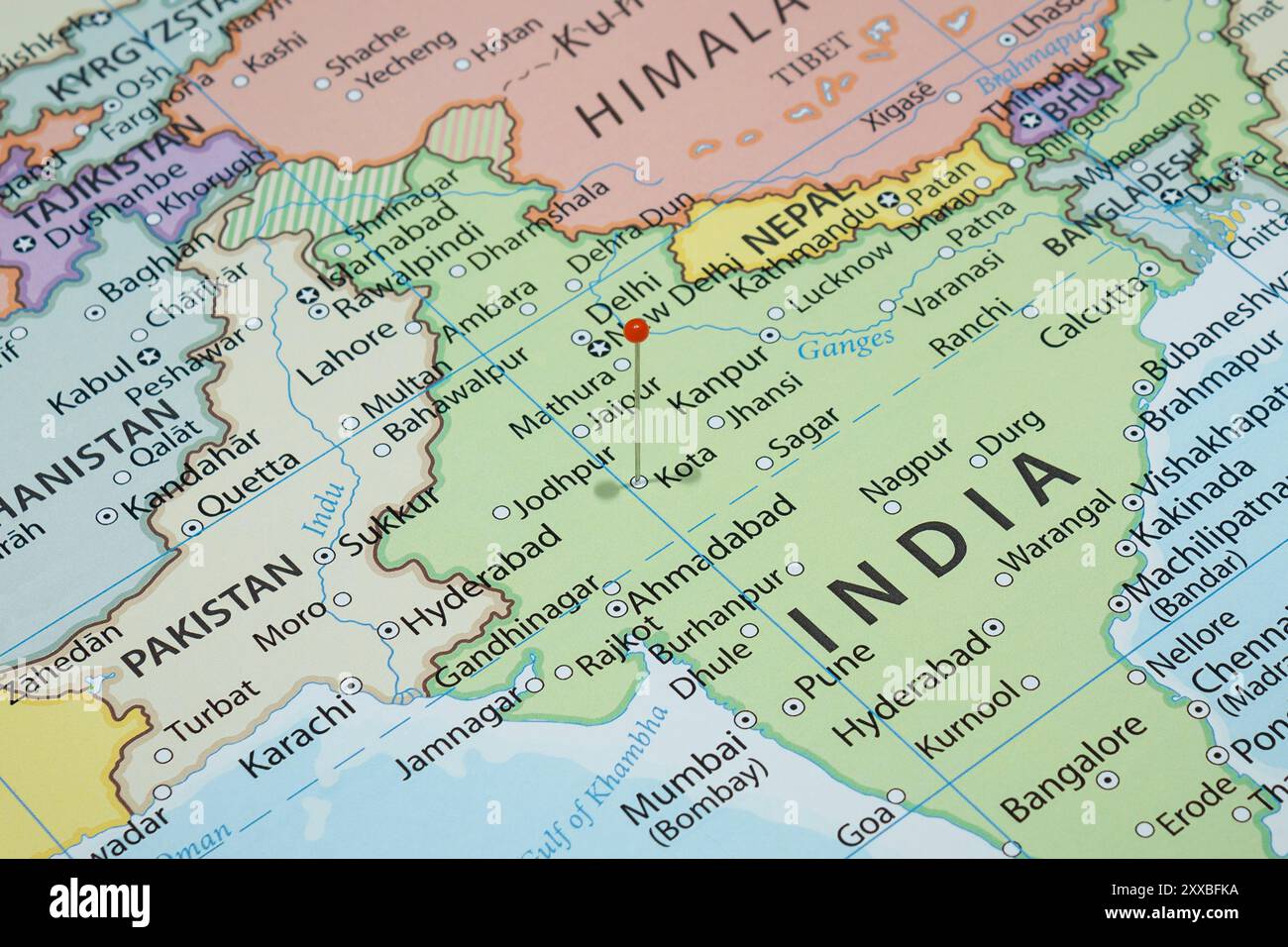 Close up to a Kota city with an orange pin needle into India country ...