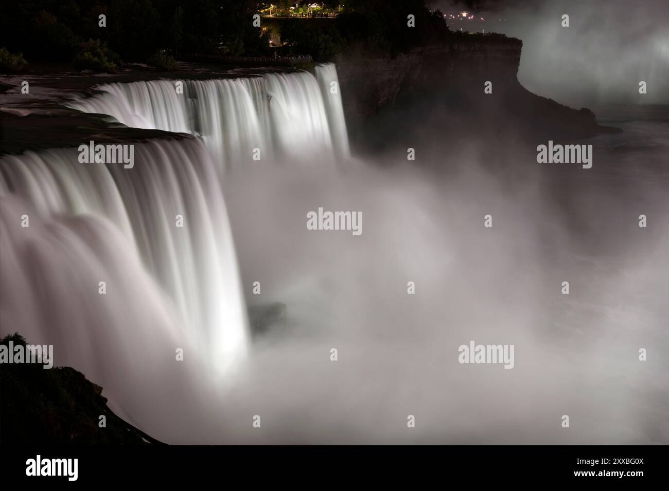 The edge of Niagara Falls at night illuminated by colorful lights Stock ...