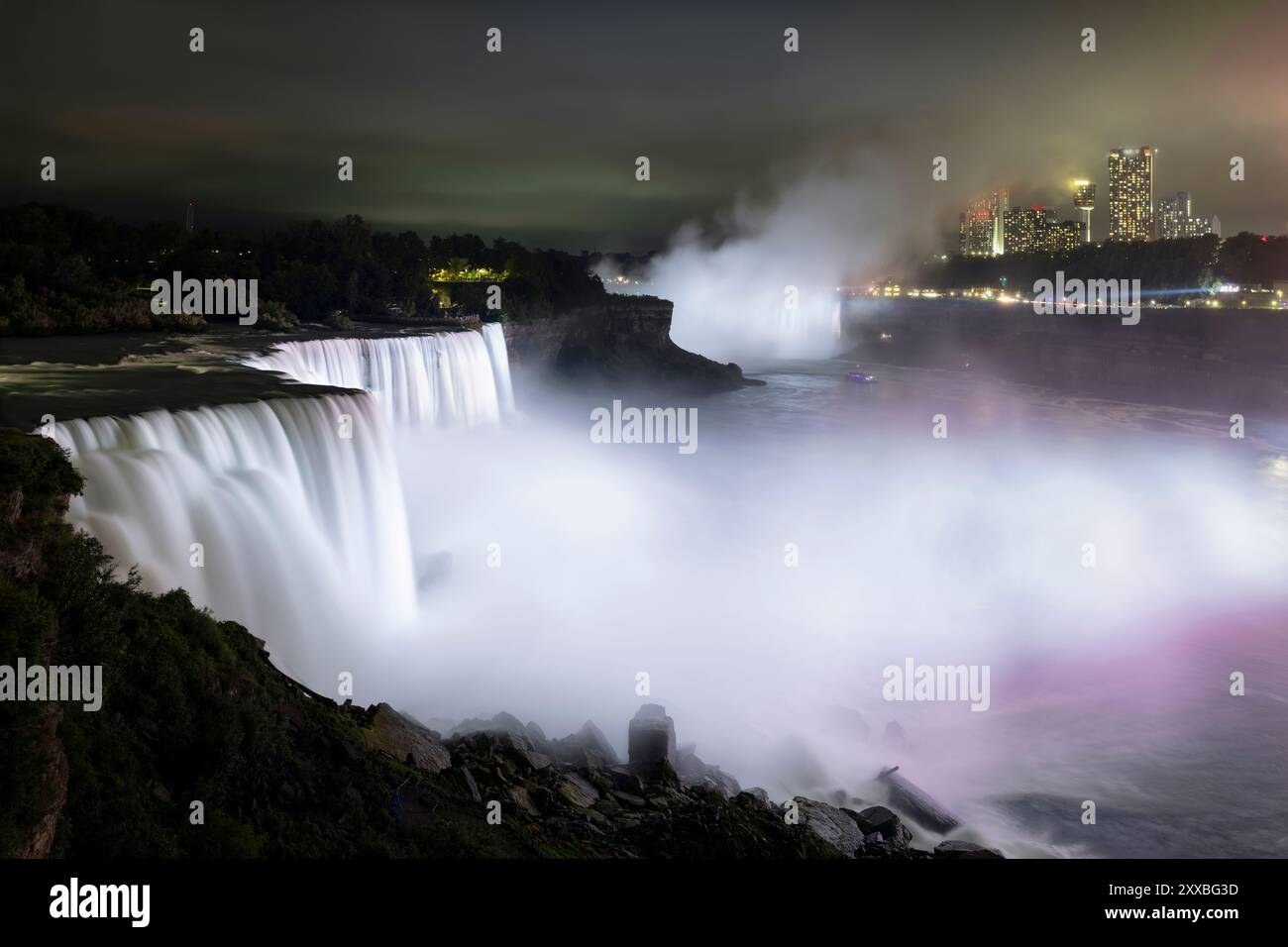 The edge of Niagara Falls at night illuminated by colorful lights Stock ...
