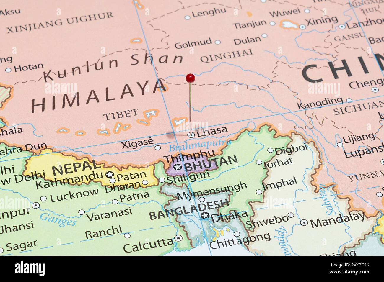 Close up to a Lhasa city into tibet region with a red pin needle into ...