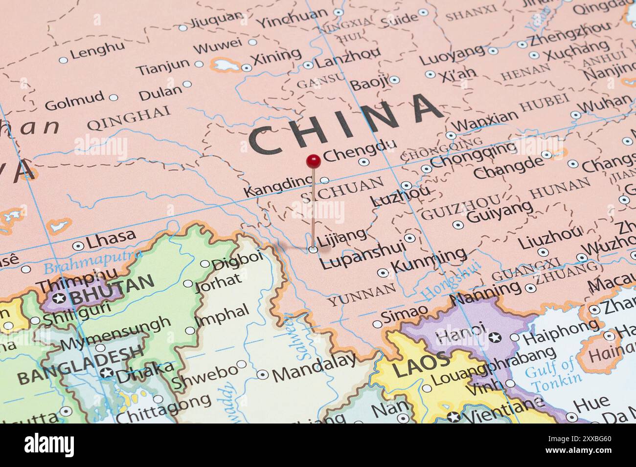 Close up to a Lijiang city with a red pin needle into China country ...