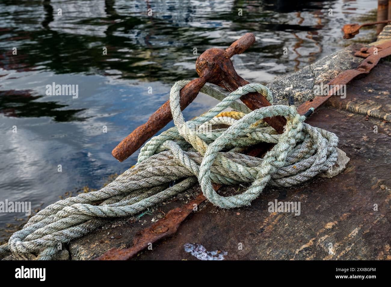 Old rusty mooring bollard in fjord harbor in Norway Stock Photo - Alamy