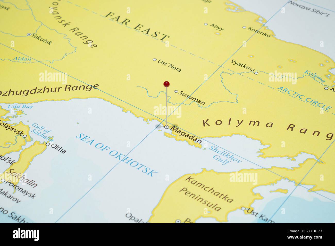 Close up to a Magadan city with a red pin needle into Russia country ...