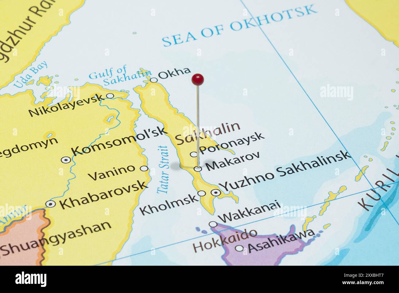 Close up to a Makarov city with a red pin needle into Russia country ...