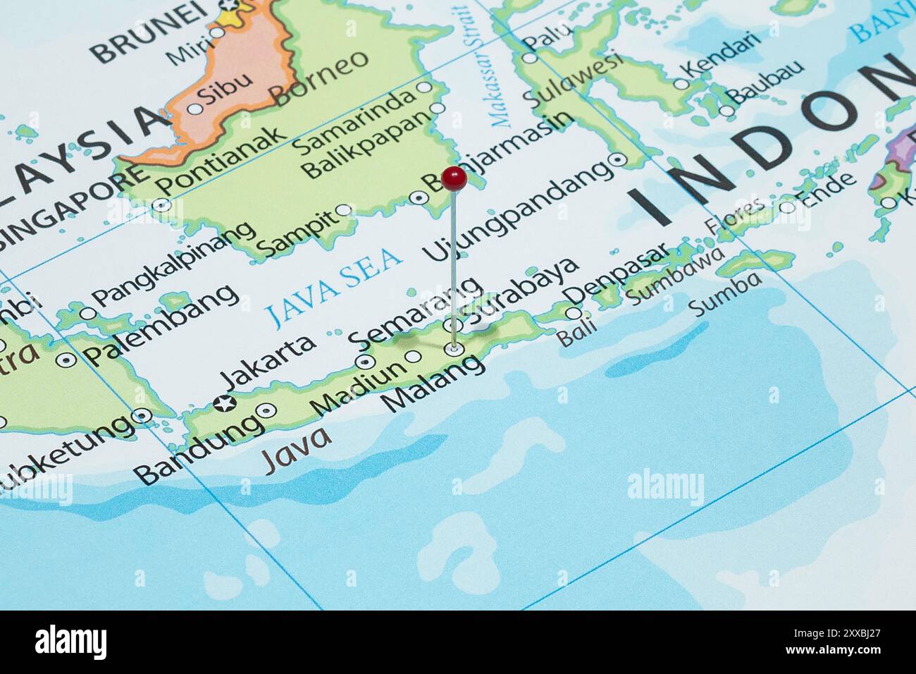 Close up to a Malang city with a red pin needle into Indonesia country ...