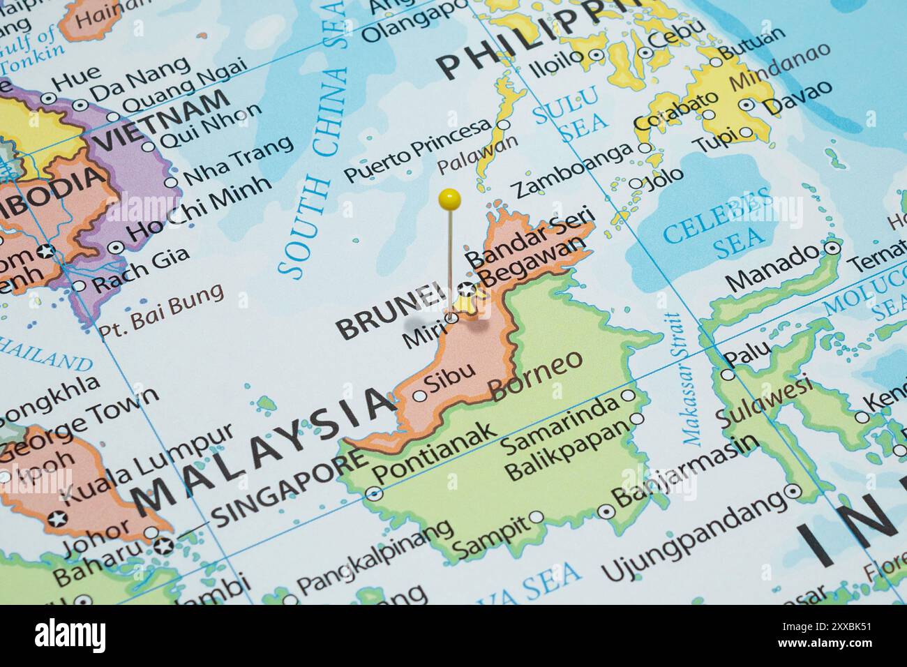 Close up to a Miri city with a yellow pin needle into Malaysia country ...