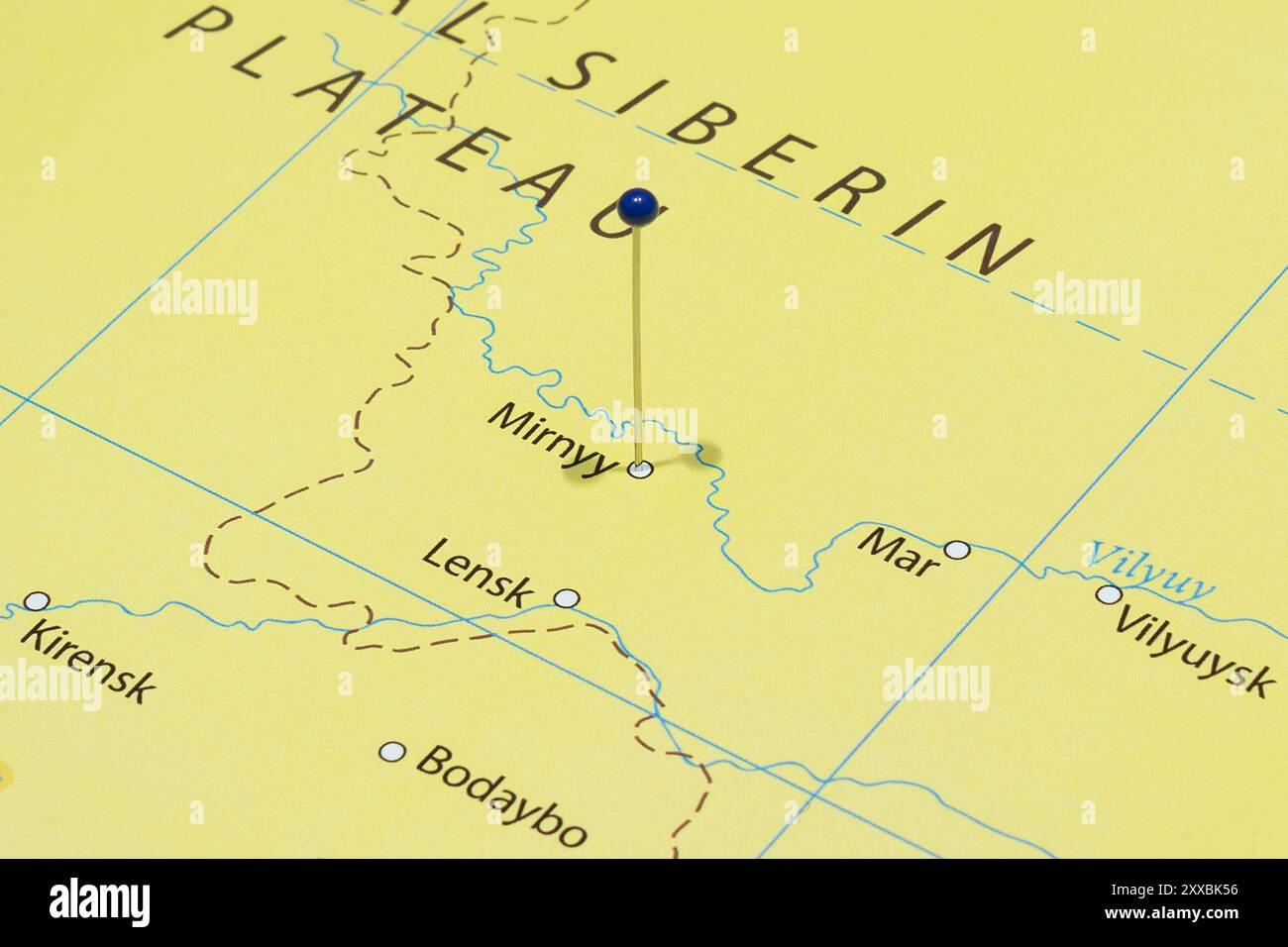 Close up to a Mirny city with a blue pin needle into Russia country ...