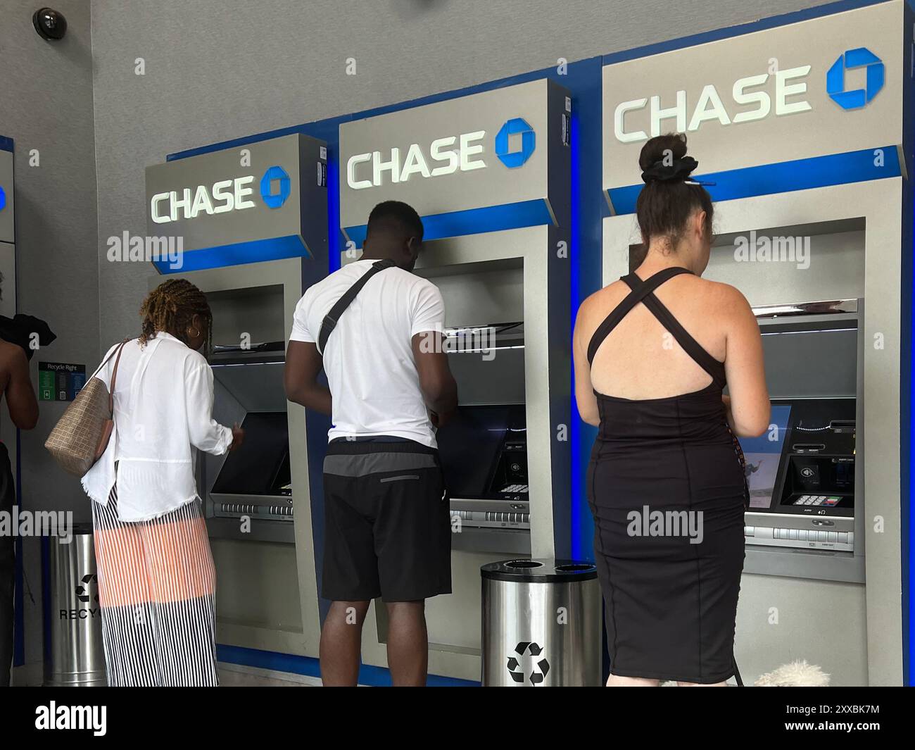 Customers use automated teller machines at a Chase Bank on a hot summer ...