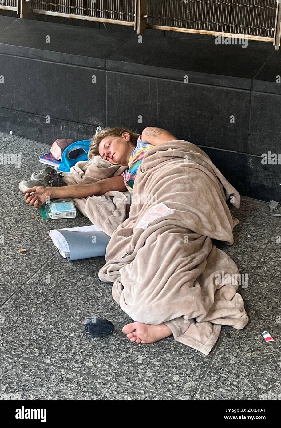 Homeless woman sleeps during the day outside a subway station on 2nd ...
