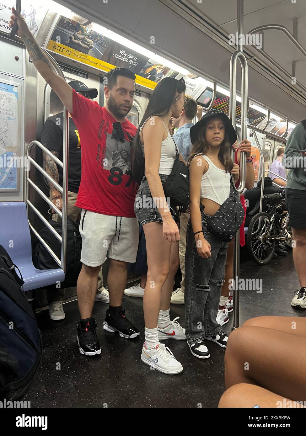Family members ride a subway train together in Brooklyn, New York Stock ...