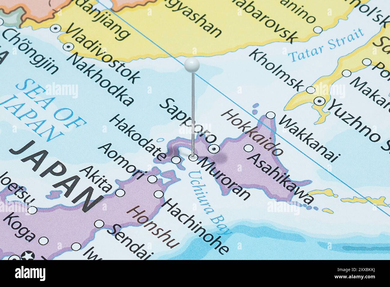 Close up to a Muroran city with a white pin needle into Japan country ...