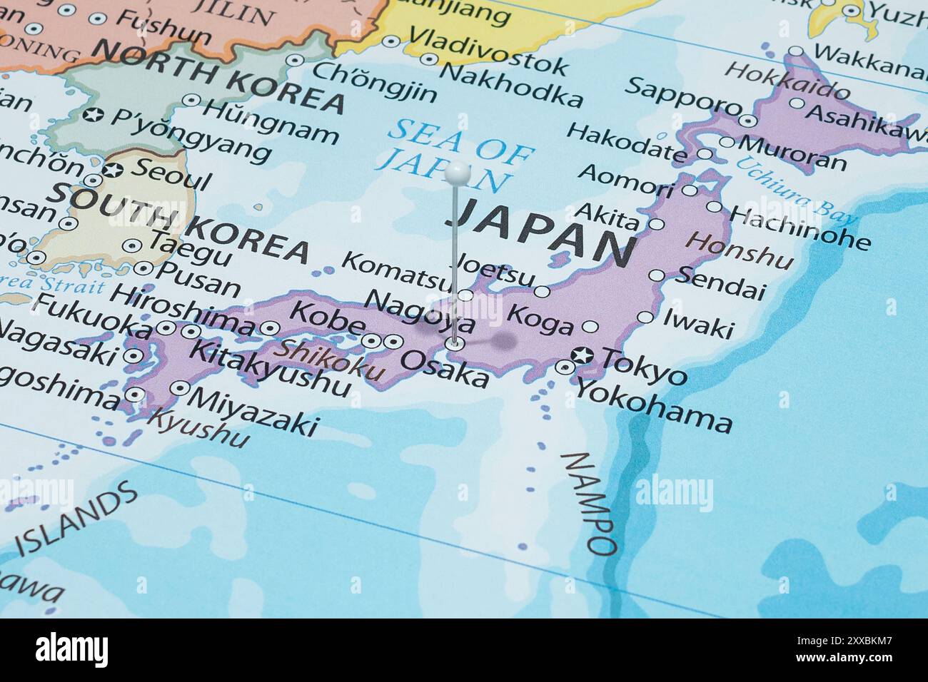 Close up to a Nagoya city with a white pin needle into Japan country ...