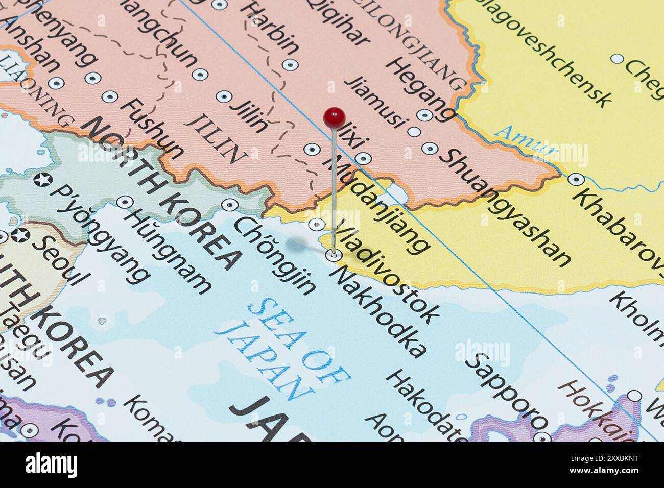 Close up to a Nakhodka city with a red pin needle into Russia country ...