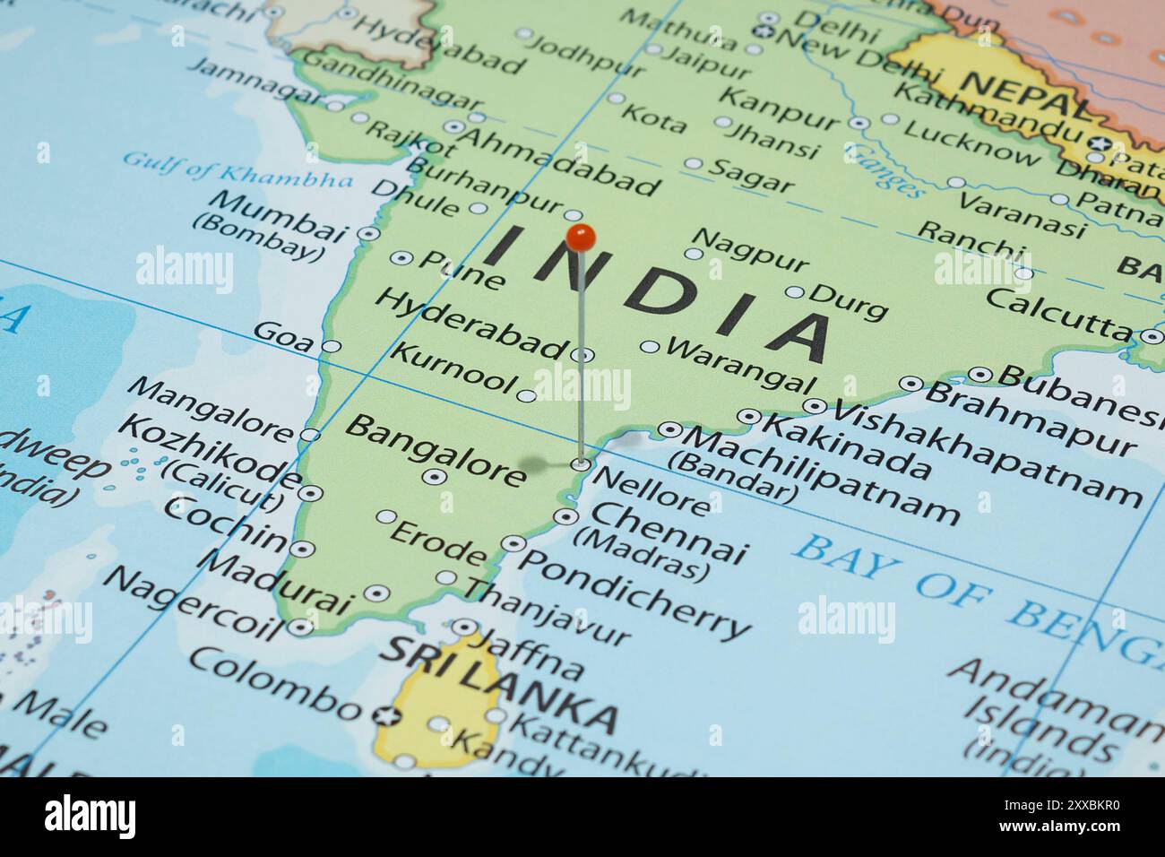 Close up to a Nellore city with an orange pin needle into India country ...