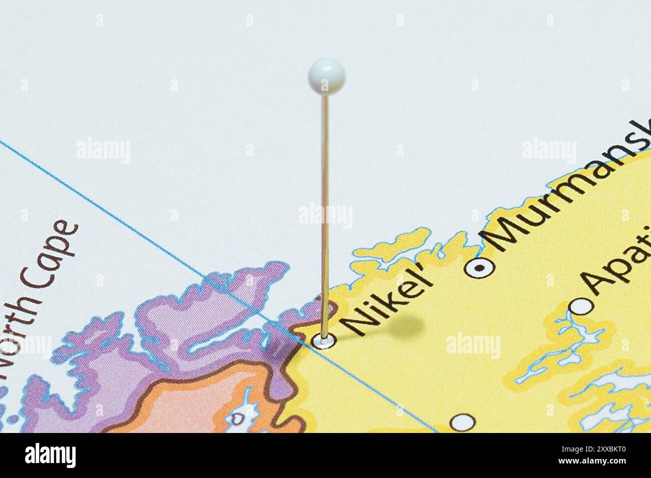 Close up to a Nikel city with a white pin needle into Russia country ...